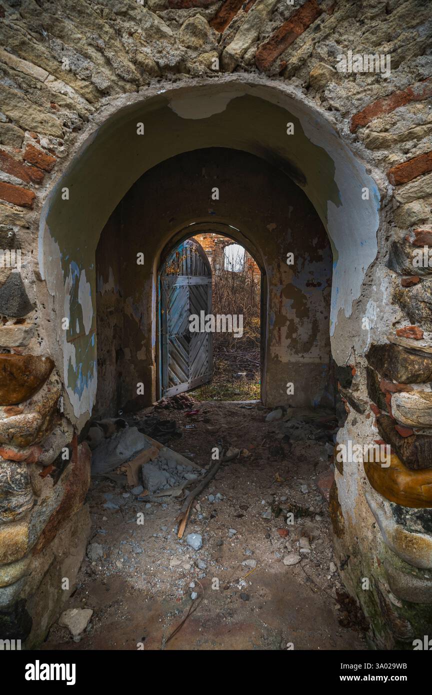 Through an arched portal, a glimpse into decay: a forgotten passage ...