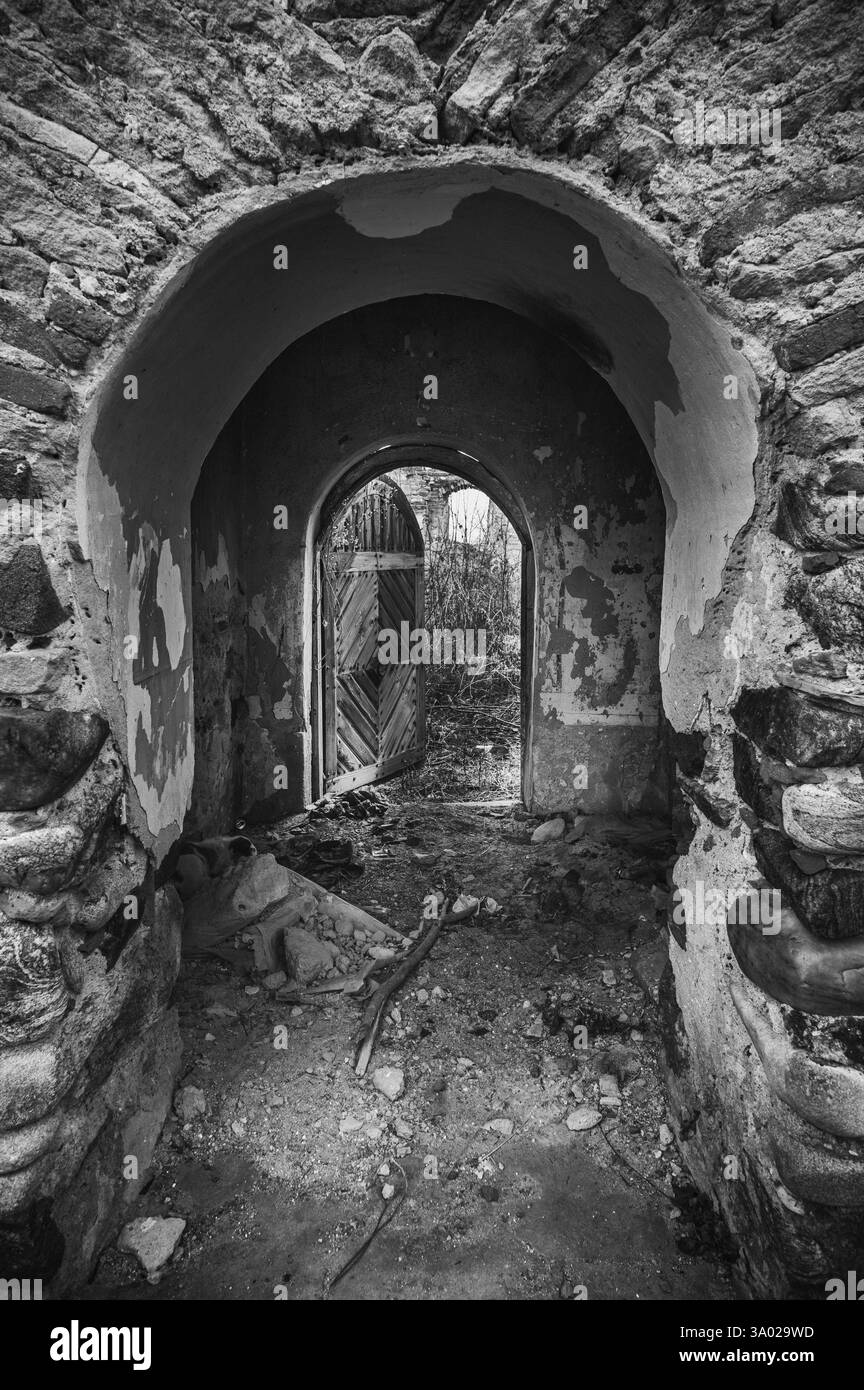 Through an arched portal, a glimpse into decay: a forgotten passage ...