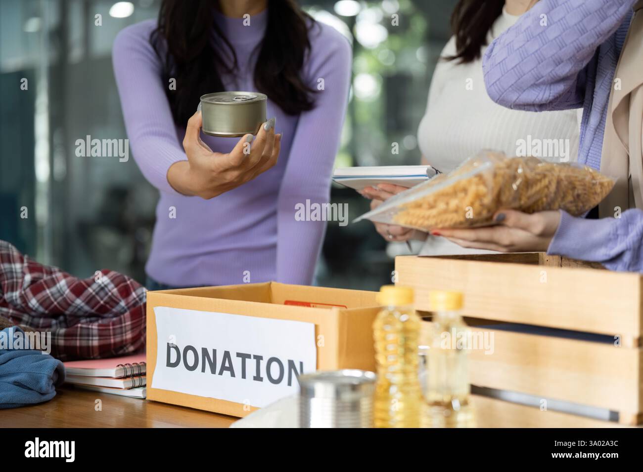 Group of women collecting food donations for community support Stock ...