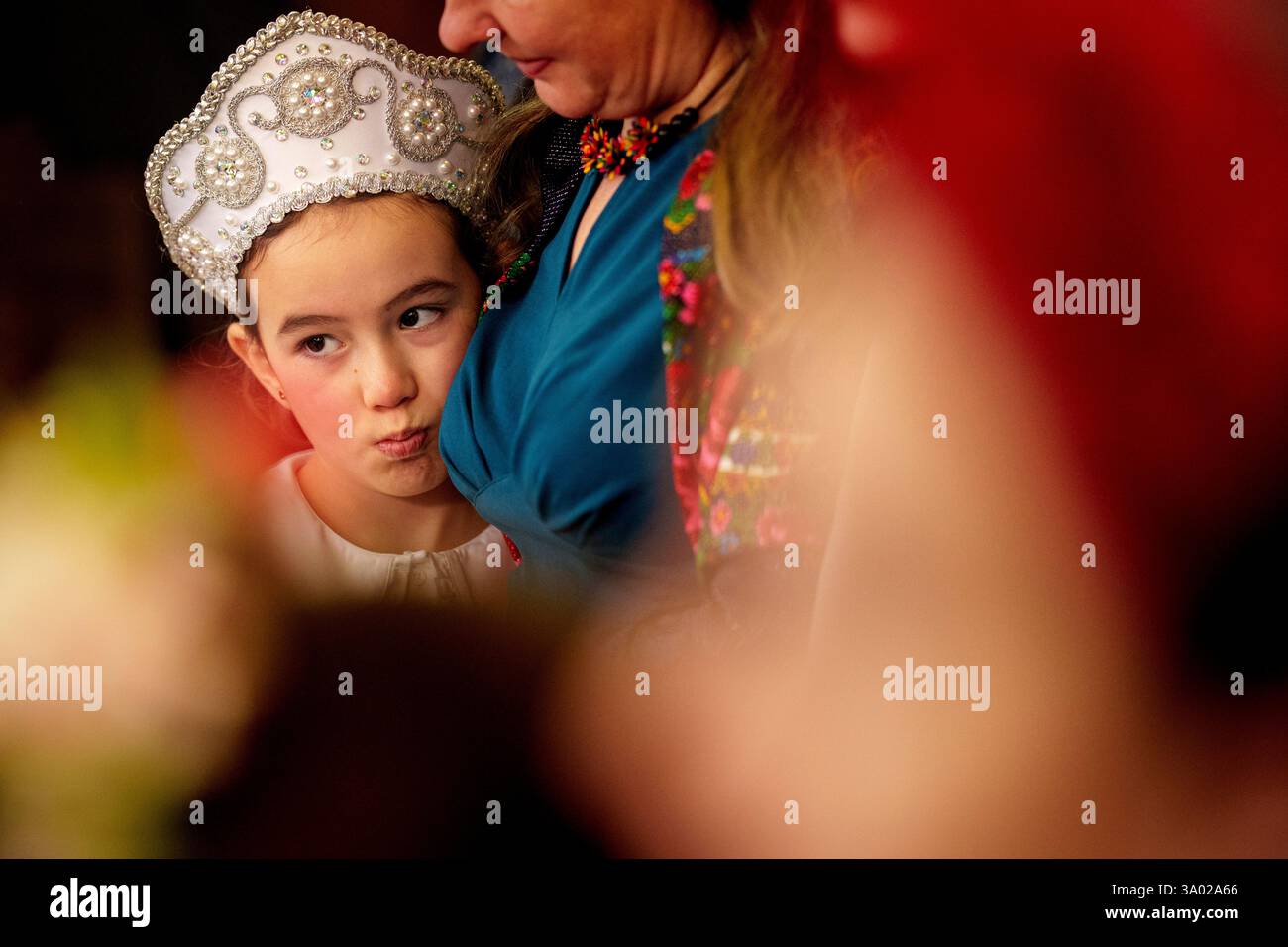 A child of a Romanian ethnic Lipovan Russian group leans on a woman ...