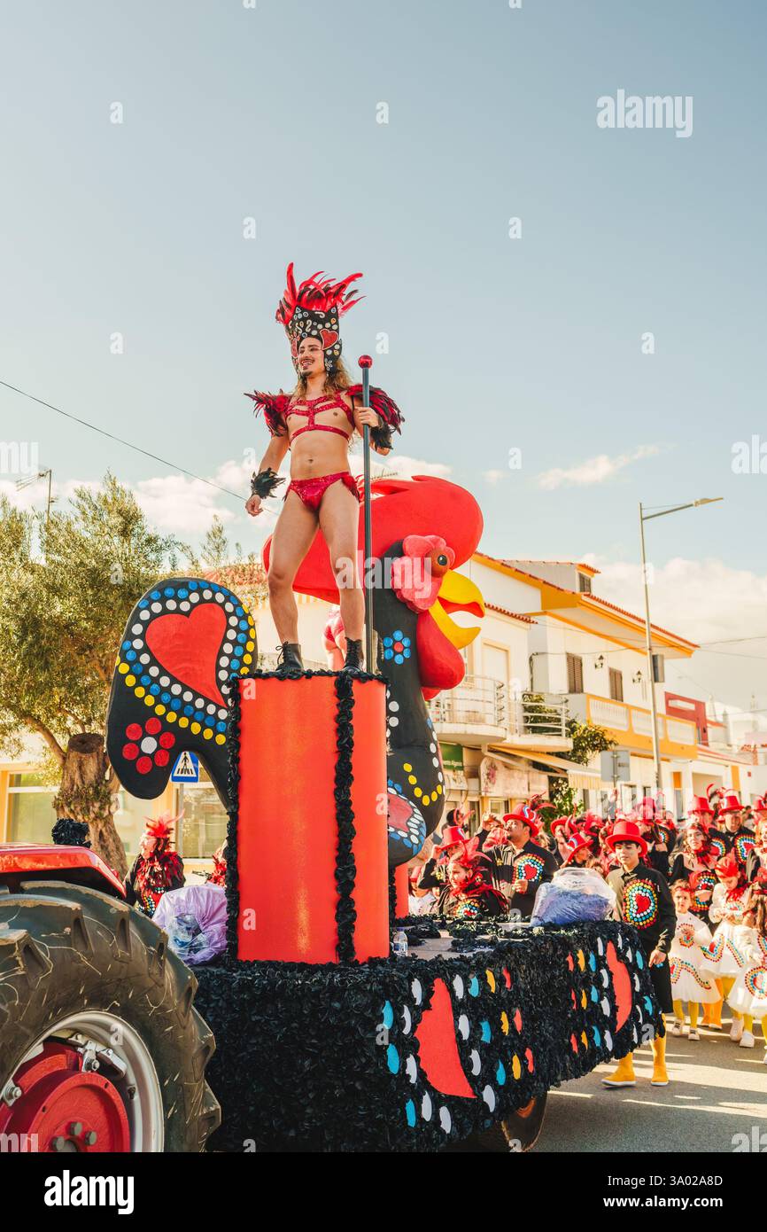 Altura, Portugal, March 1, 2025. Parade performer in a red carnival ...