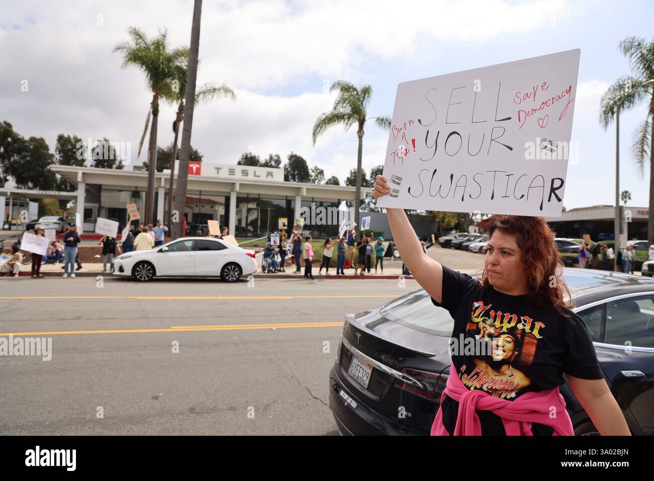 March 1, 2025, Santa Barbara, Ca, USA: A woman in Tupac Shirt holds a ...