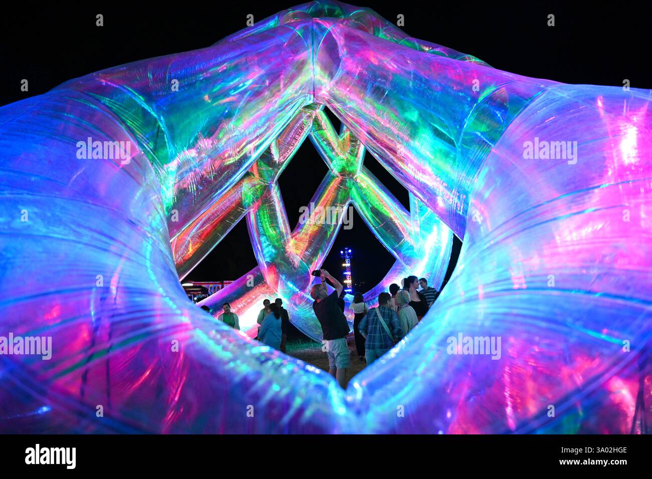 Visitors take pictures inside a light installation at the Canberra 2025 ...