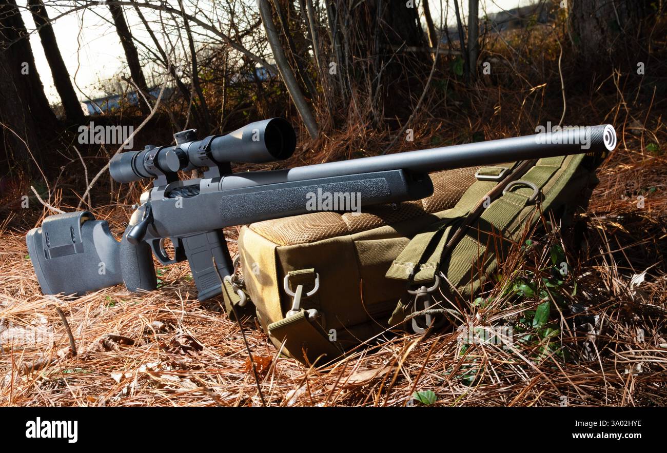 Black bolt action rifle with a high powered scope mounted laying on a ...