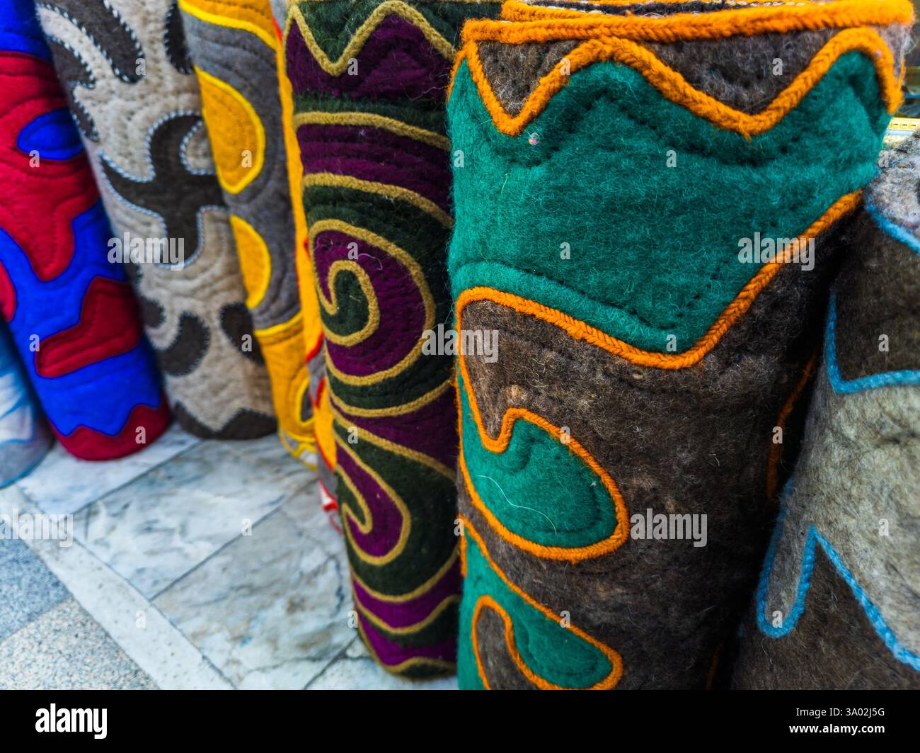 stack of standing rolls of shyrdak - national Kyrgyz felt rugs Stock ...