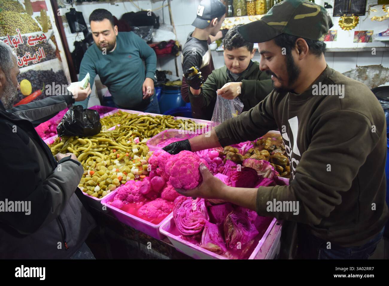 Tripoli, Lebanon. 1st Mar, 2025. People purchase pickled vegetables at ...