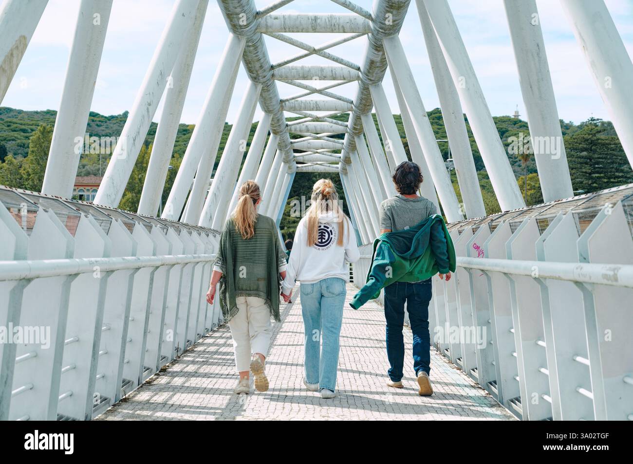 A family strolls across a bridge, heading towards the Monsanto forest park Stock Photo - Alamy