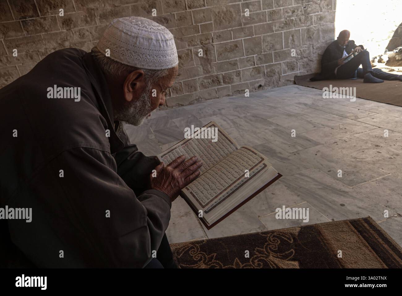 Muslim worshippers read from the Holy Quran as they sit at the historic ...
