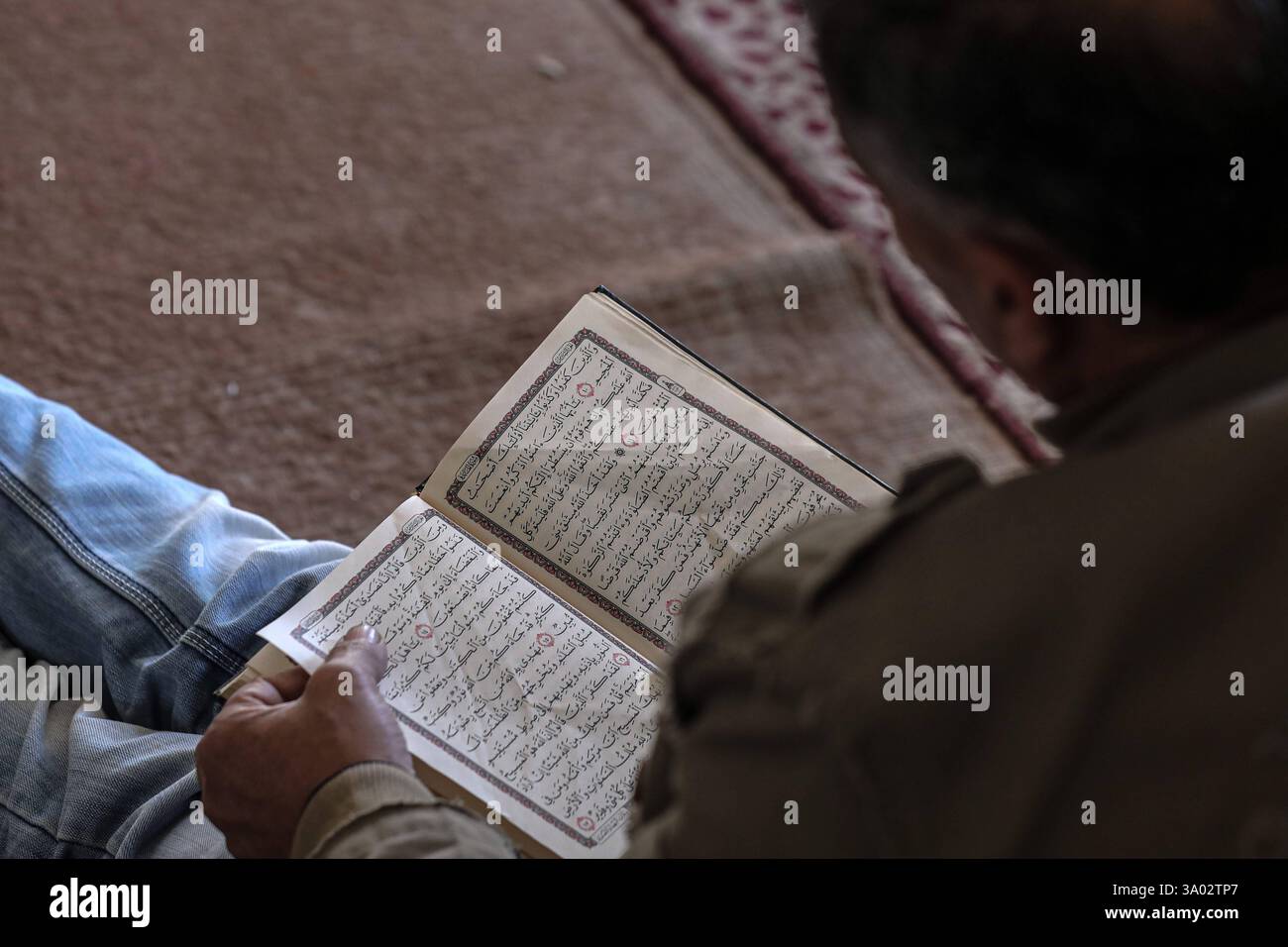 Muslim worshippers read from the Holy Quran as they sit at the historic ...