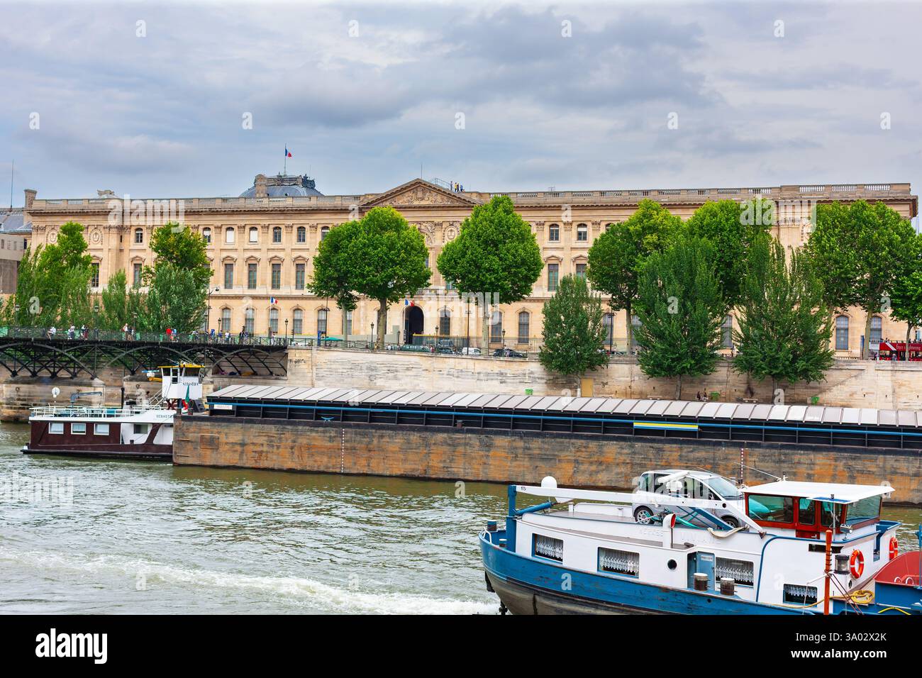 Paris, France - July 21, 2010 : Ferries and barges sail down Seine ...