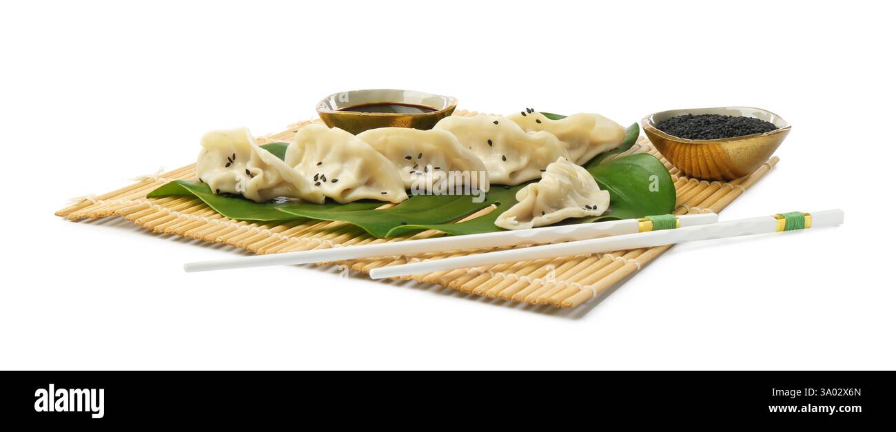 Tasty boiled gyoza (dumplings) with soy sauce, chopsticks and sesame on ...
