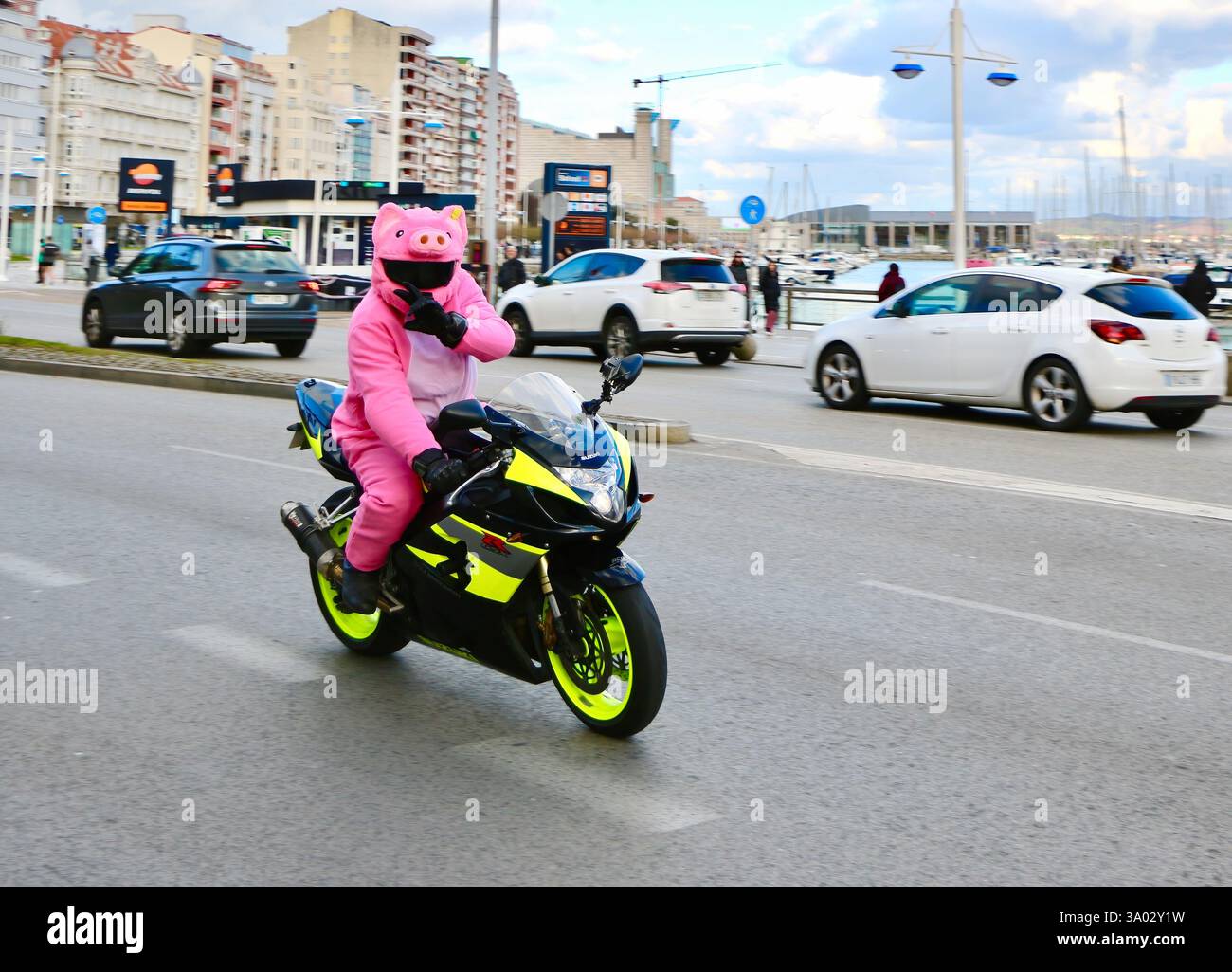 Motorbike rider arriving to the evening carnival parade wearing a ...