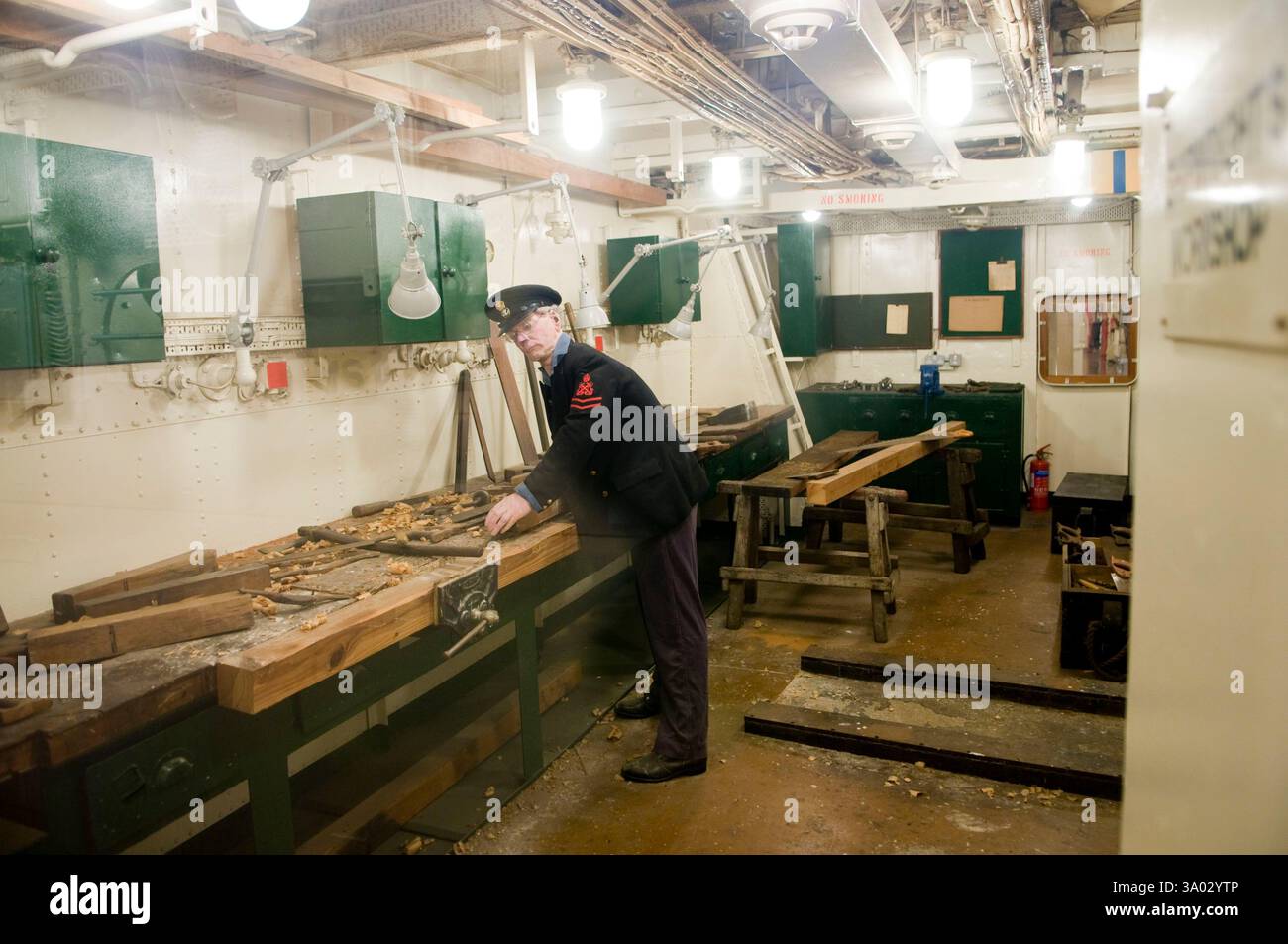 Shipwright works on a workbench in the HMS Belfast's (London, UK) ship ...