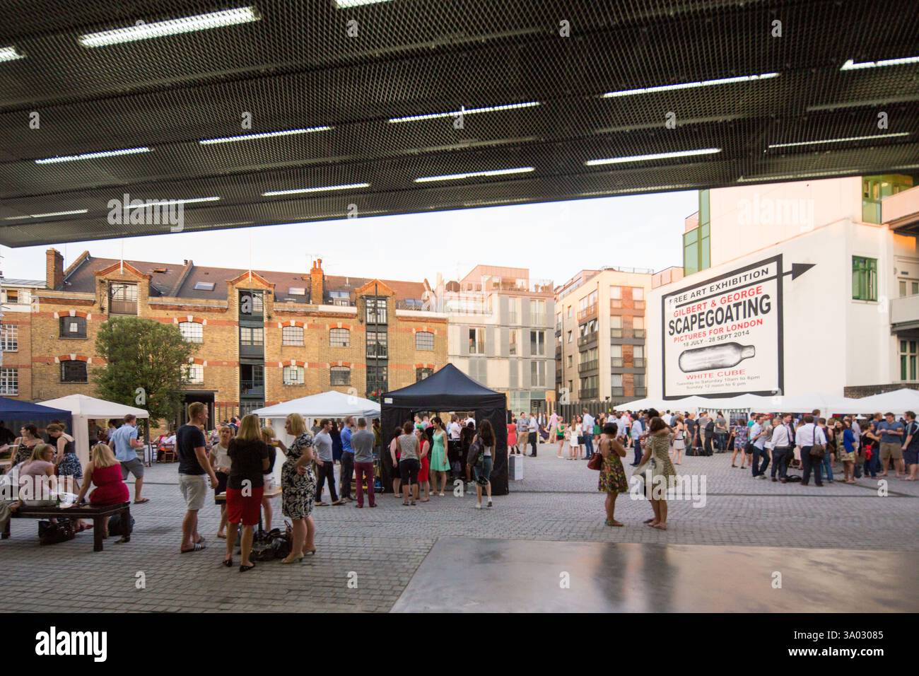 Crowds gather at White Cube, London, for a Gilbert & George exhibition ...