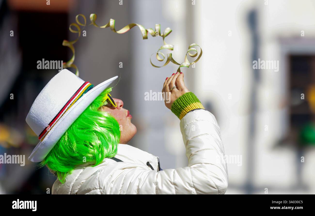 02 March 2025, Baden-Württemberg, Riedlingen: A woman dressed as a fool ...