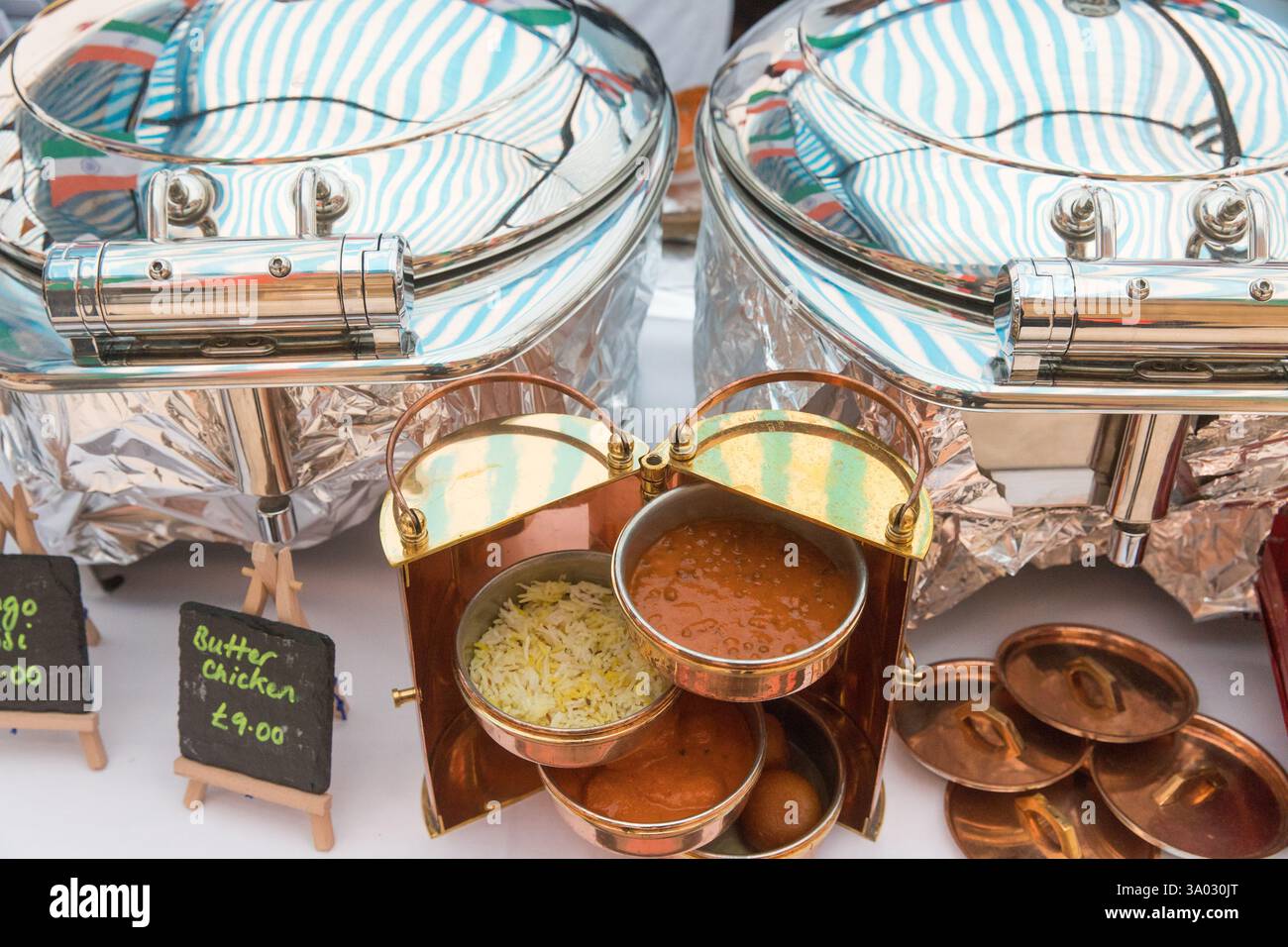 Indian food stall at a market. Butter chicken (£9) and other dishes ...