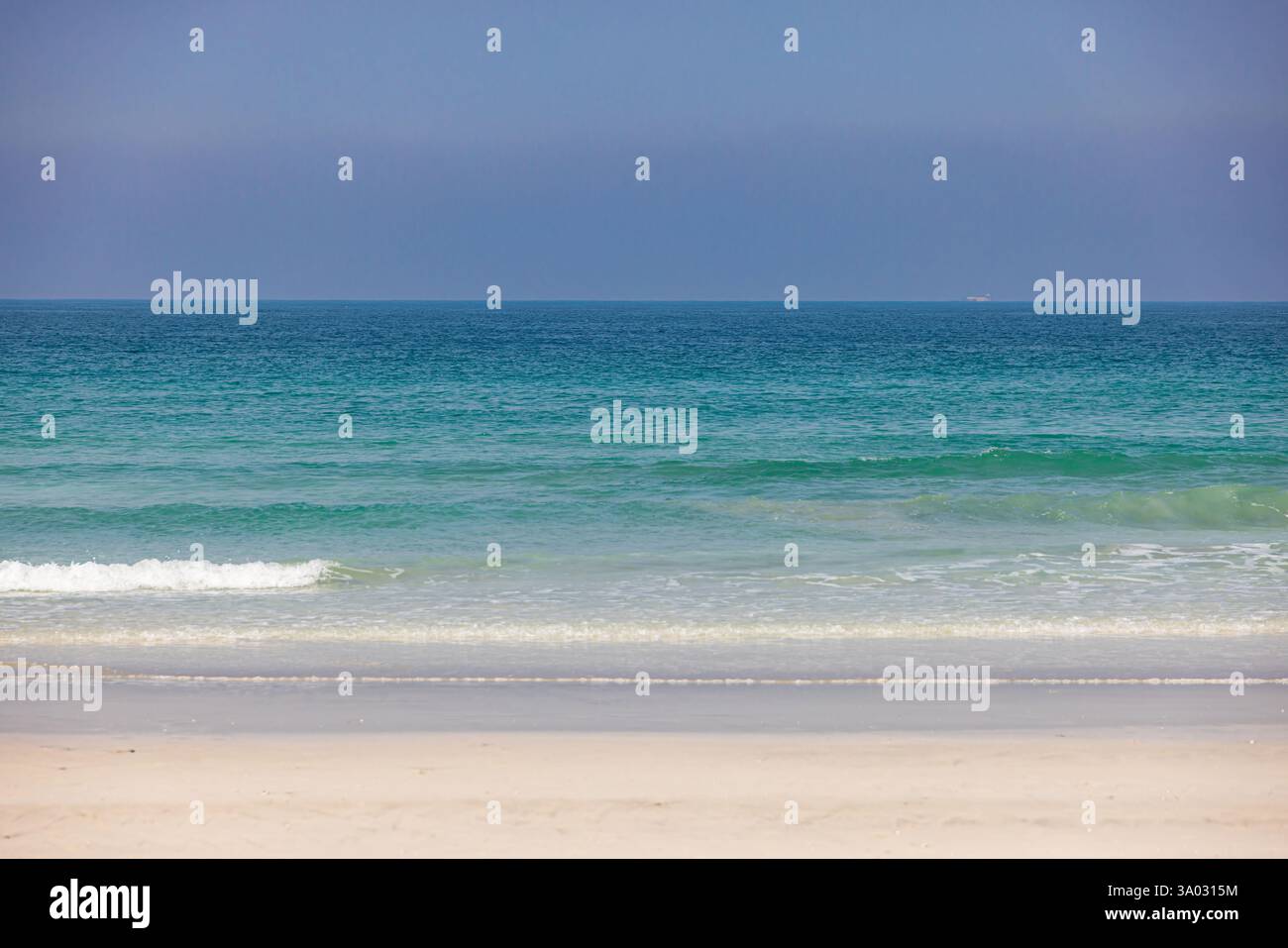 A pristine beach with turquoise waters and golden sand in the UAE ...