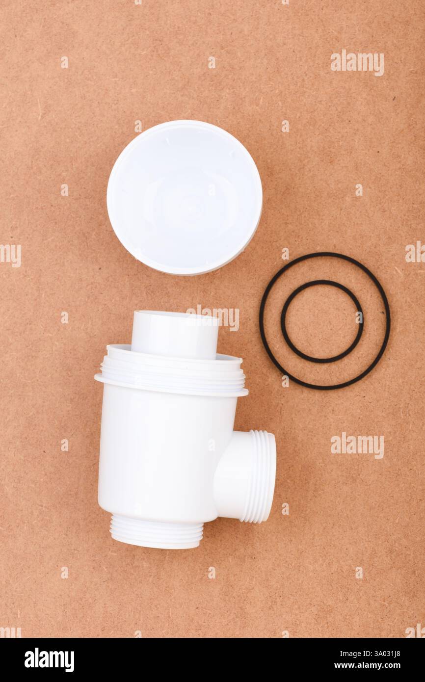 White plastic sink drain trap with threaded ends with rubber gaskets ...