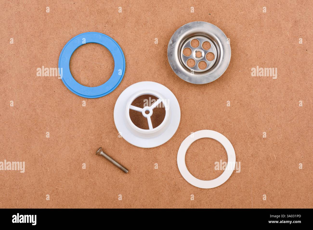 An assortment of sink drain components, including a metal strainer ...