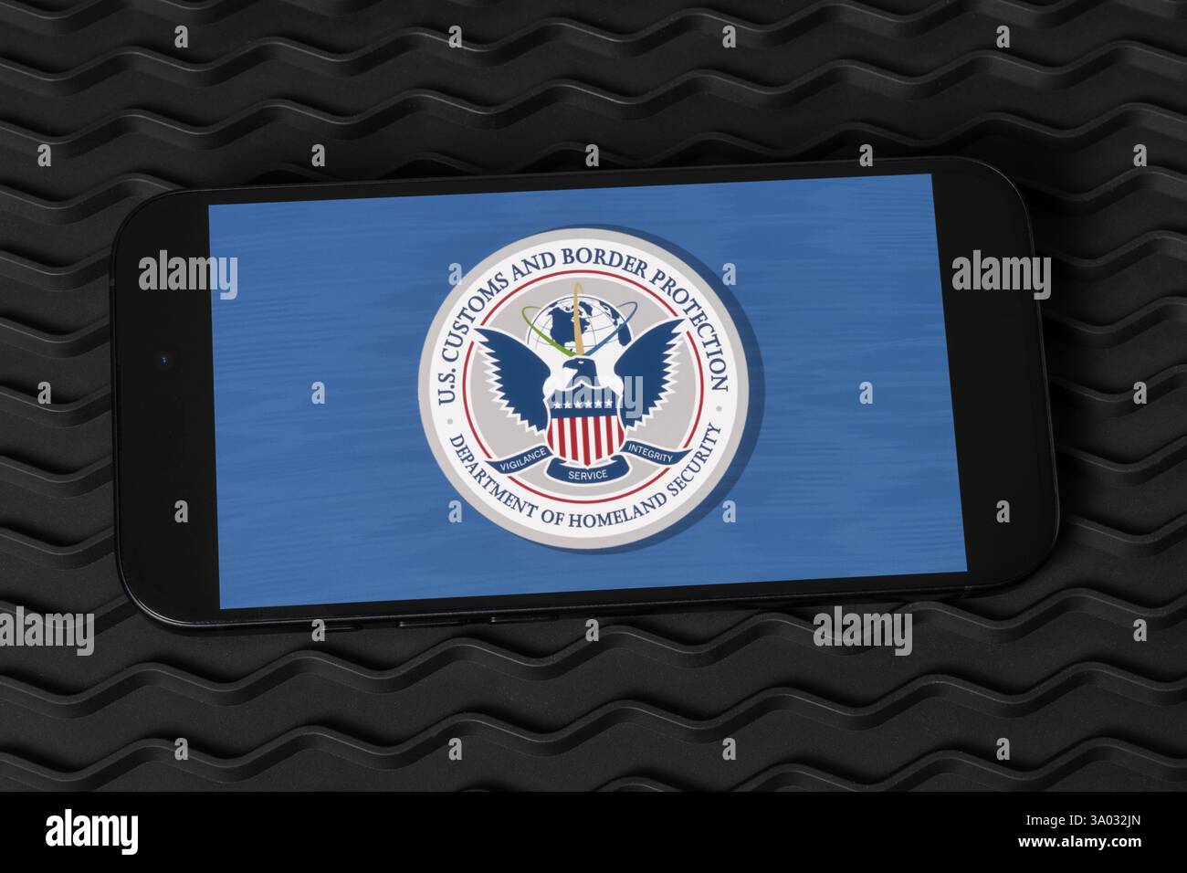 United States Customs and Border Protection logo on a smartphone. The ...