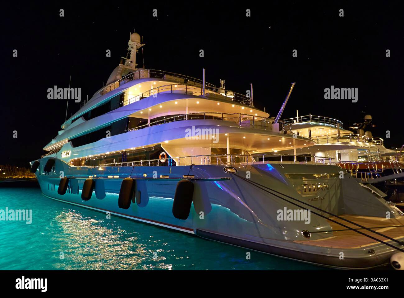 Luxurious Illuminated Superyachts Anchored at Night in a Serene Marina ...
