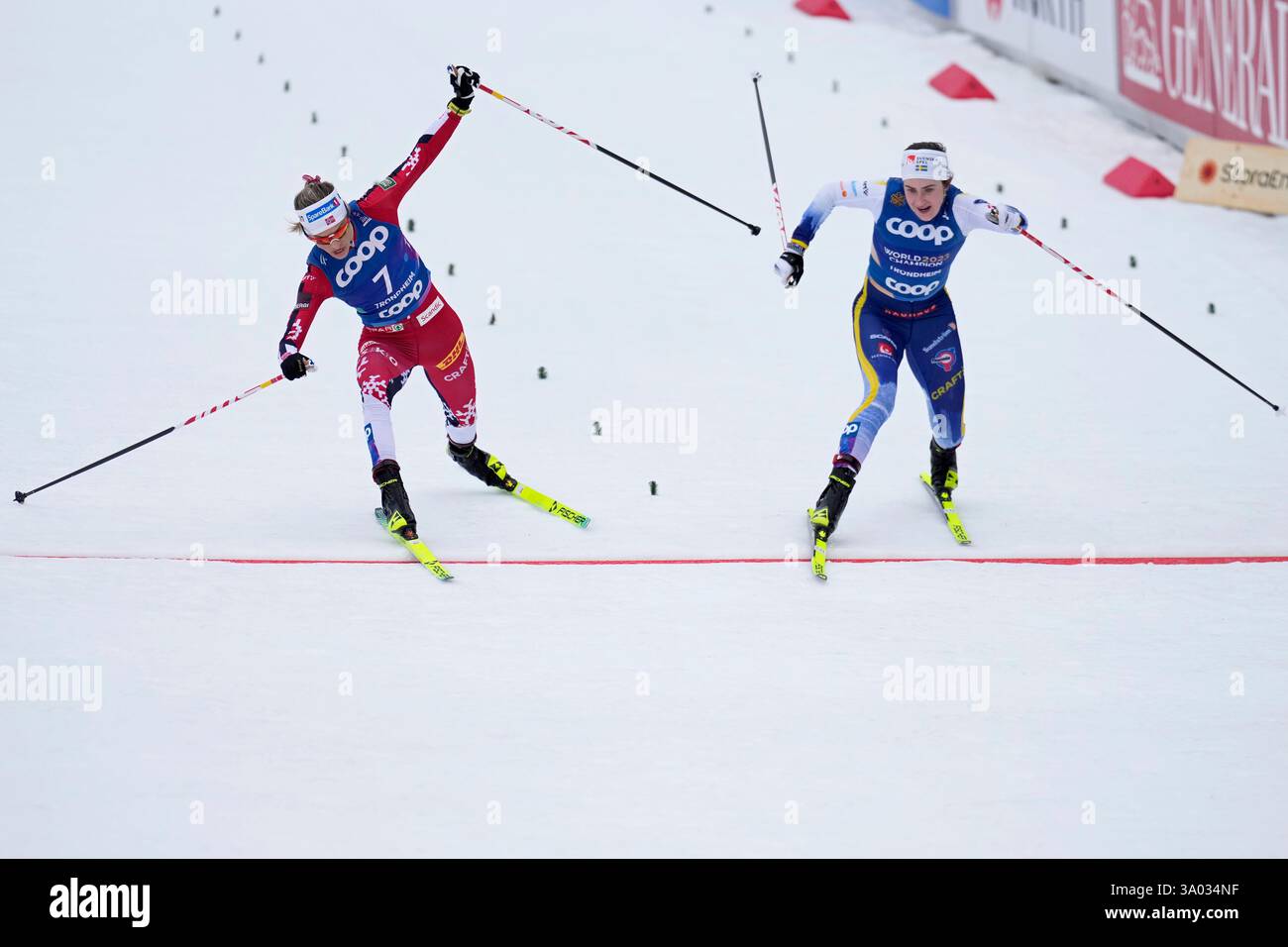Ebba Andersson, of Sweden, right, crosses the finish line slightly ...