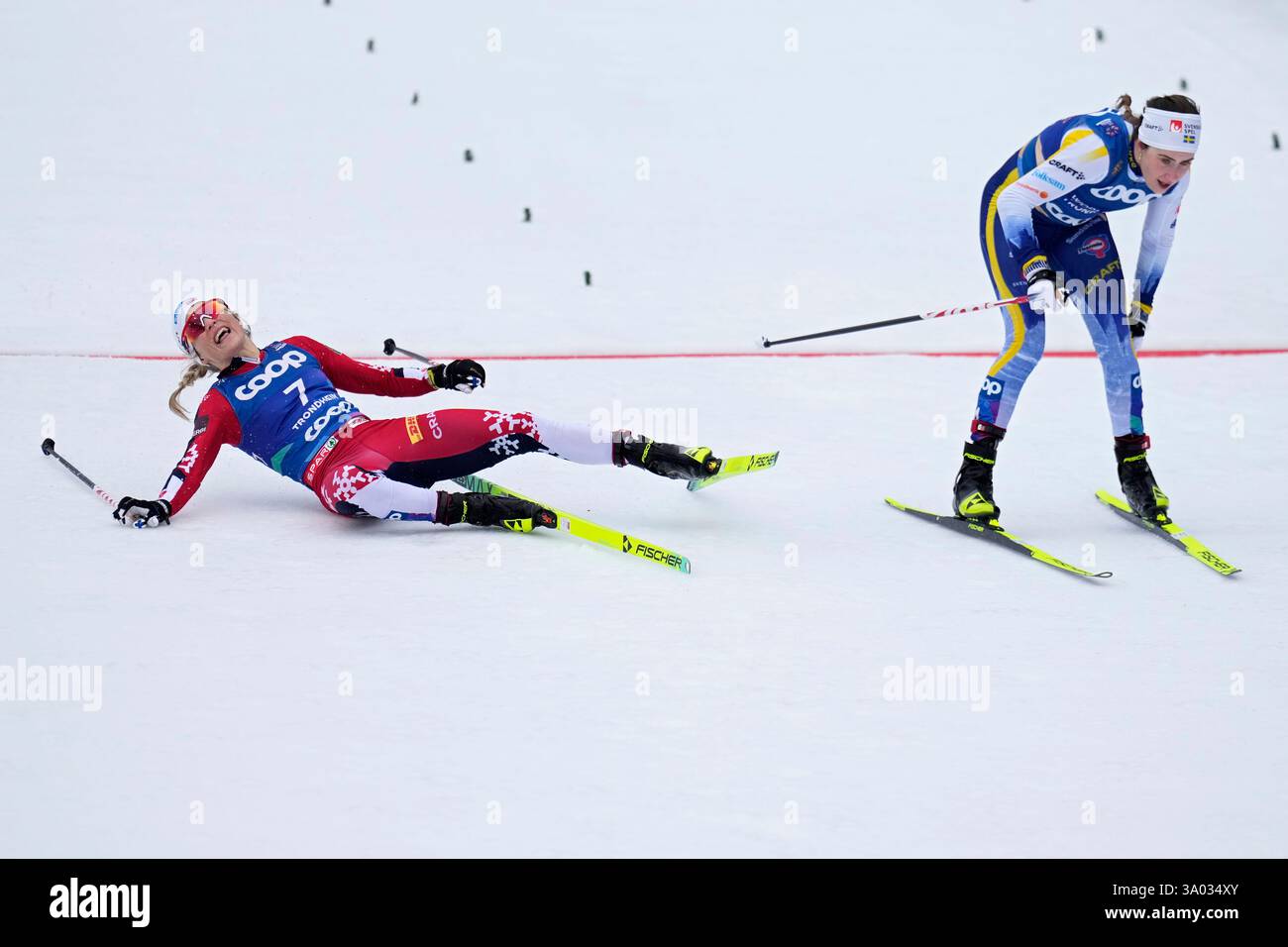 Ebba Andersson, of Sweden, right, crosses the finish line slightly ...