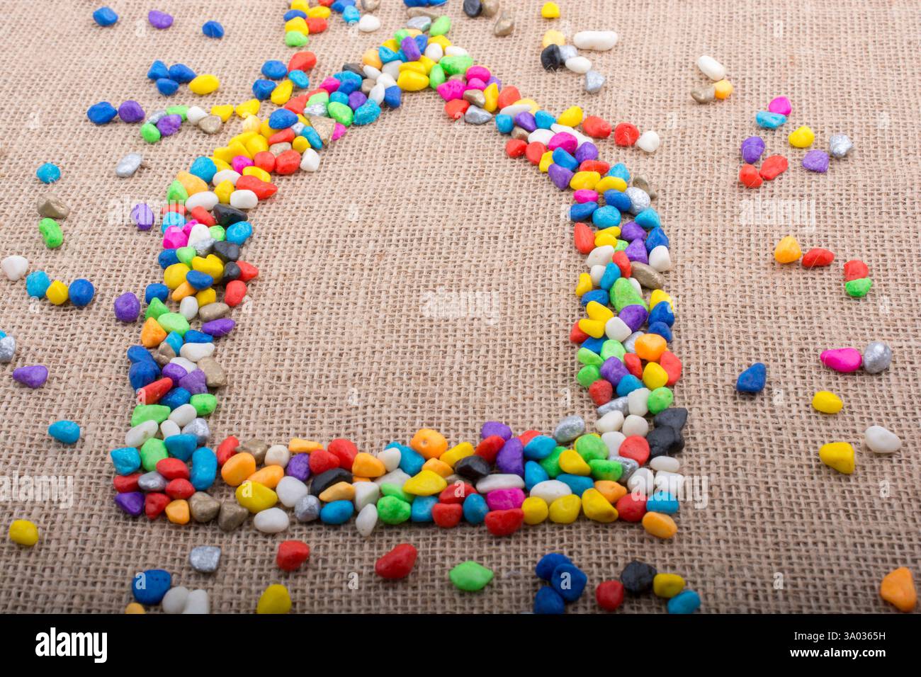 House form shaped by some colorful pebbles Stock Photo - Alamy