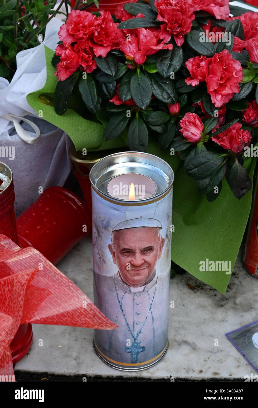 People pray near the statue of John Paul II outside the Gemelli ...