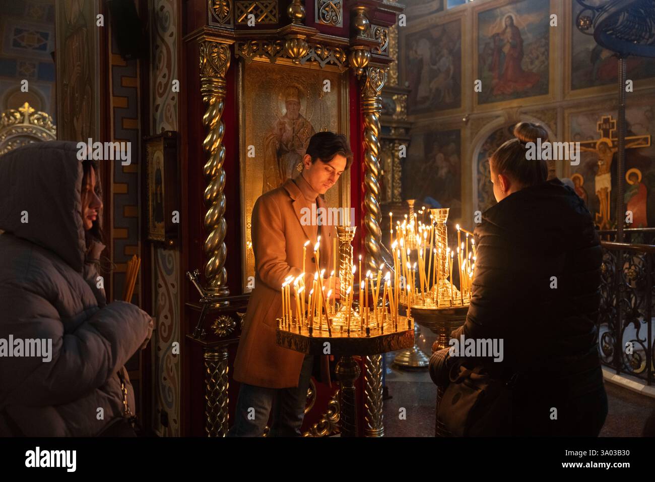 People light candles as they pray for peace in St.Michael Cathedral in ...