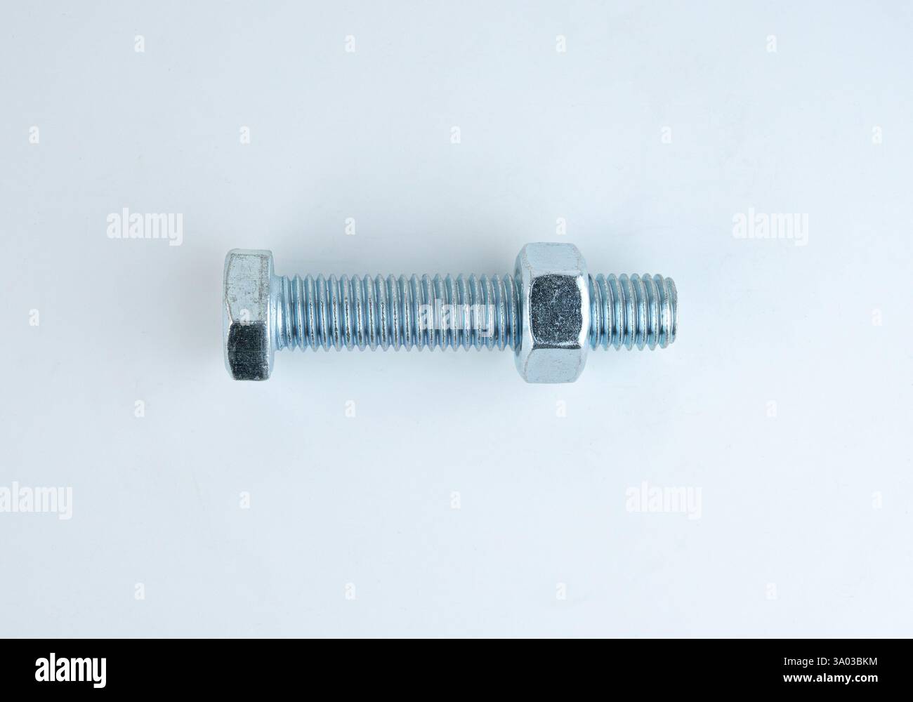 Metal bolt with nut on a plain background for hardware use Stock Photo ...