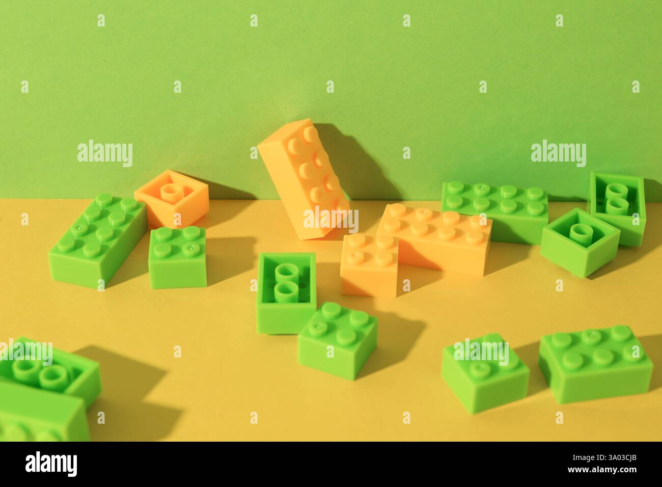 Construction toy. Colorful building bricks on color background, closeup ...