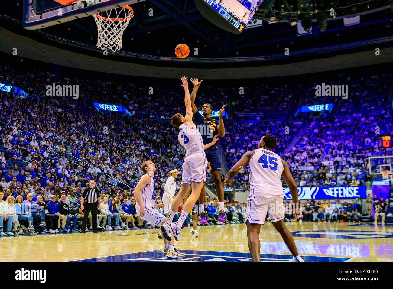 West Virginia guard Toby Okani (5) shoots the basketball over BYU guard ...