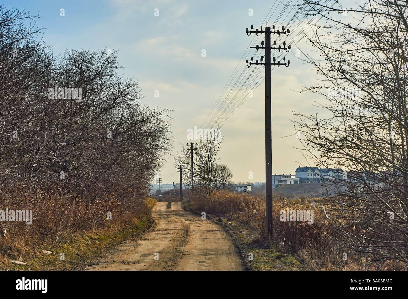 Rural Dirt Road With Utility Poles and Containers in a Countryside ...