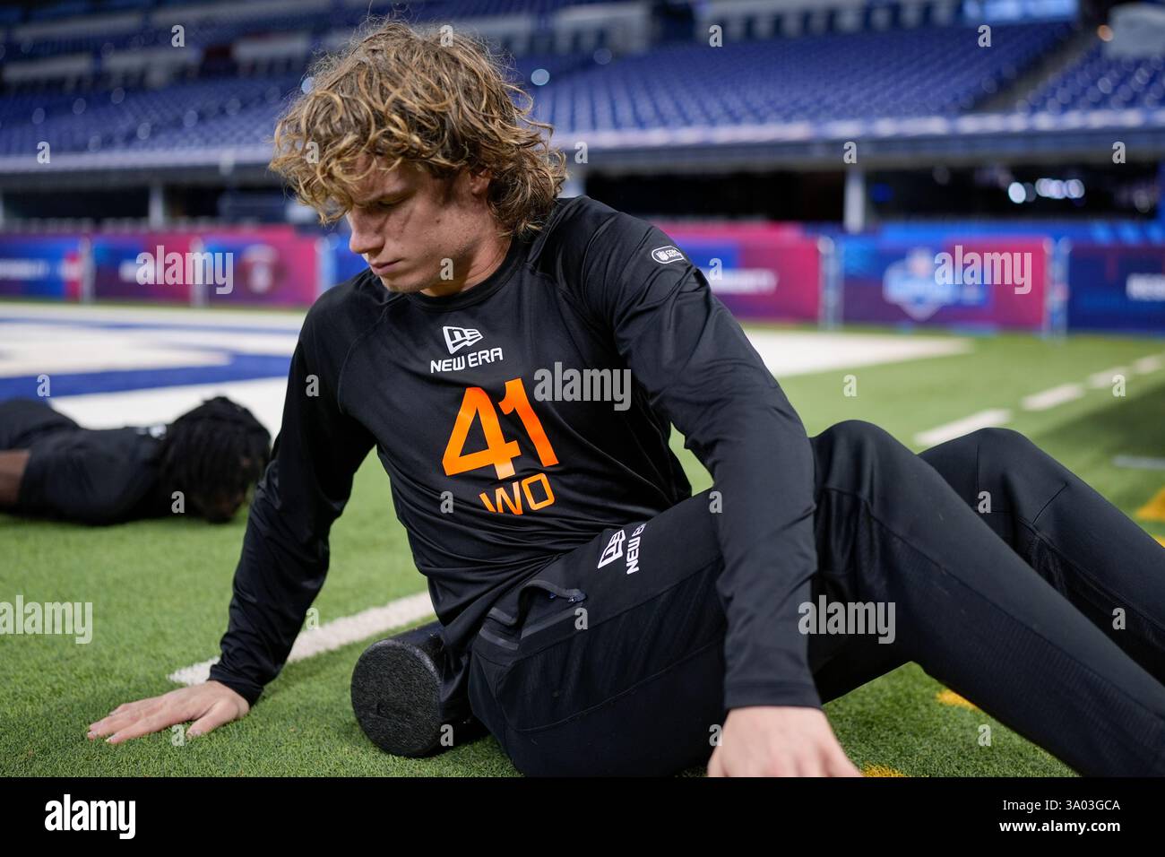 Arkansas wide receiver Isaac TeSlaa stretches before lifting weights at ...