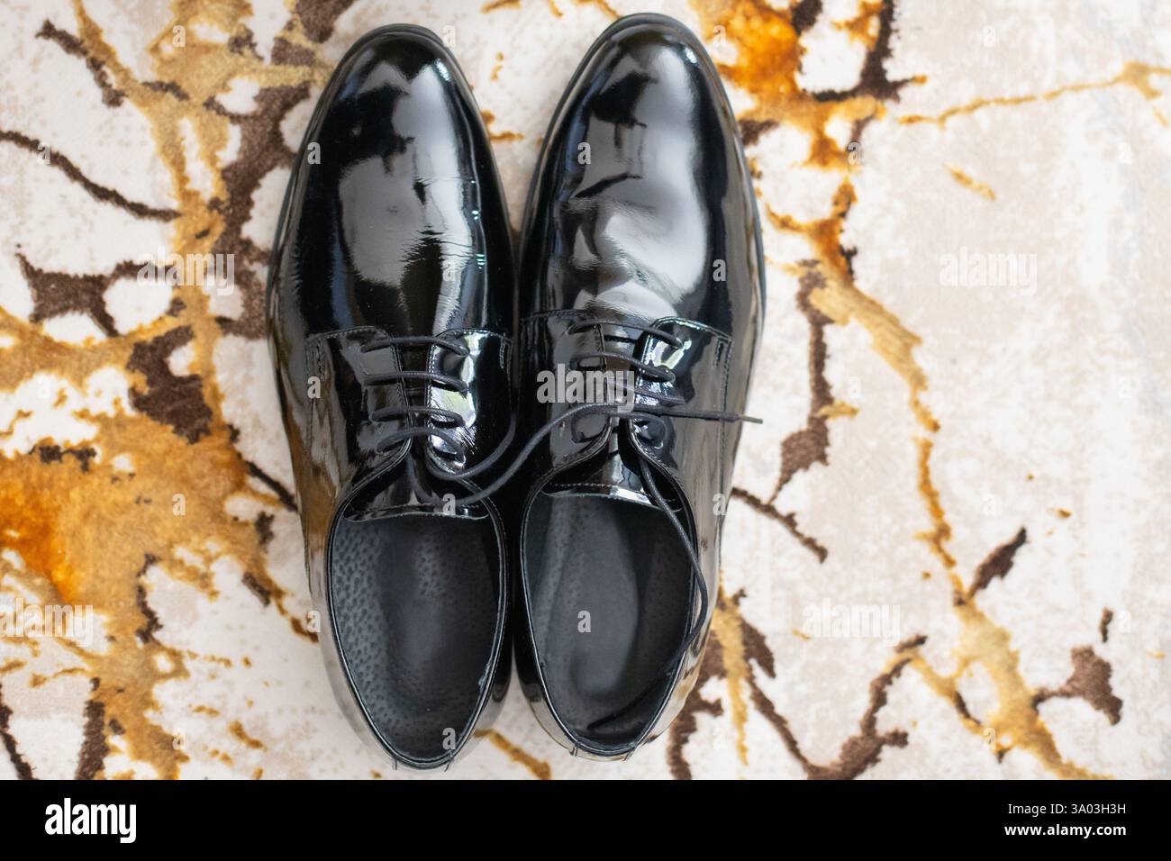 Luxurious black patent leather men's dress shoes on carpet Stock Photo ...