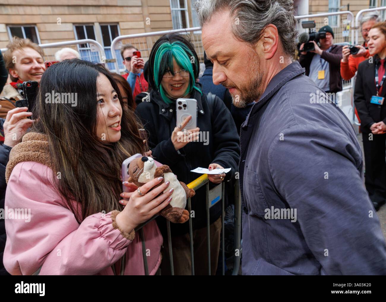 James McAvoy is handed him a soft toy while having a selfie taken with ...