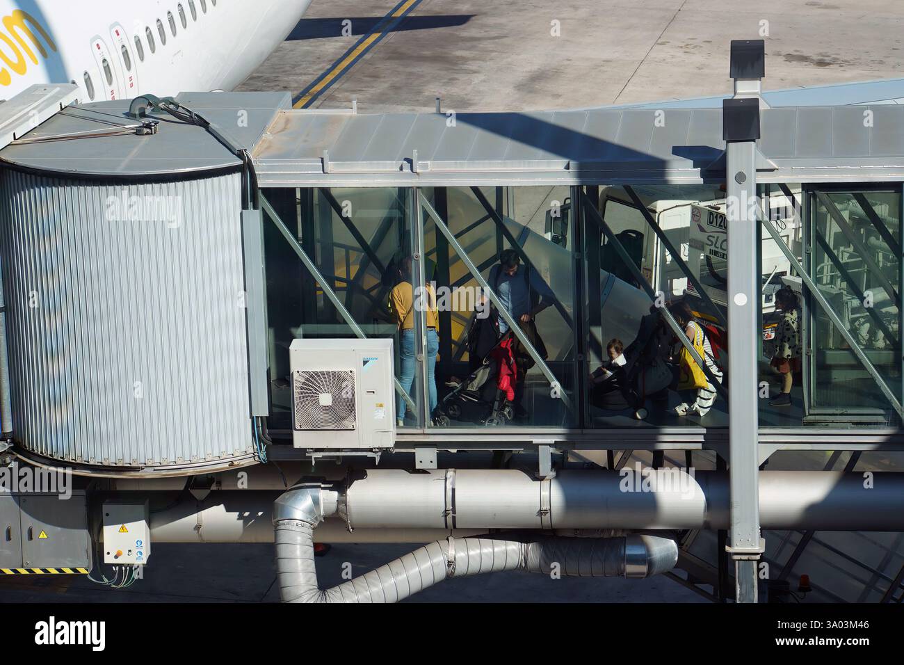 Closeup of passengers at departure gate walking through glass air ...