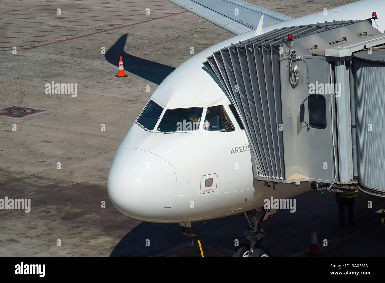 Preflight closeup of white jet cockpit and windows with pilot inside ...