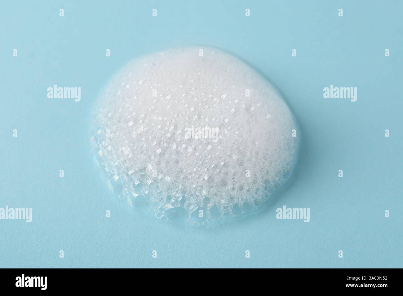 Sample of fluffy foam on light blue background, closeup Stock Photo - Alamy