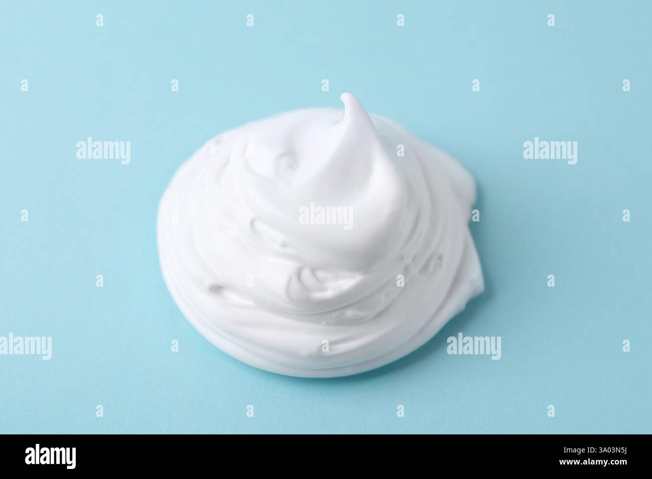 Sample of fluffy foam on light blue background, closeup Stock Photo - Alamy