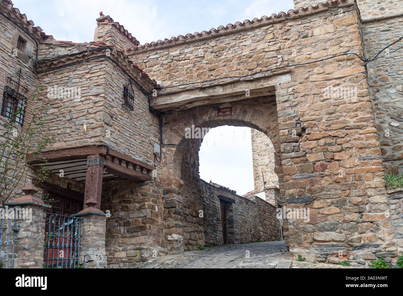 Ancient stone gate known as the River Gate in Yanguas, Soria, with ...