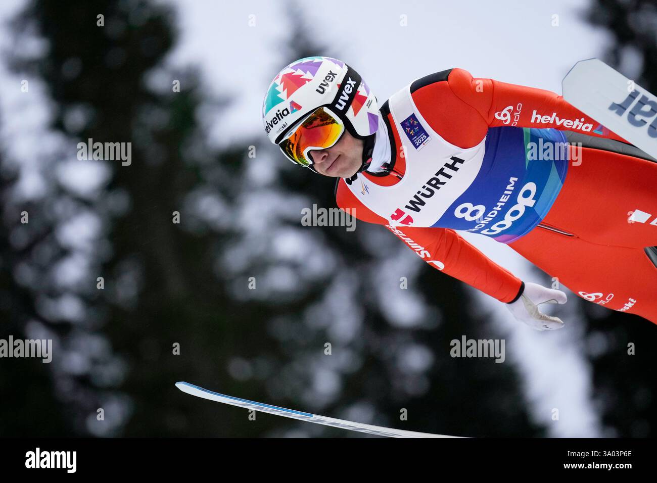 Simon Ammann, of Switzerland, soars through the air during his first ...