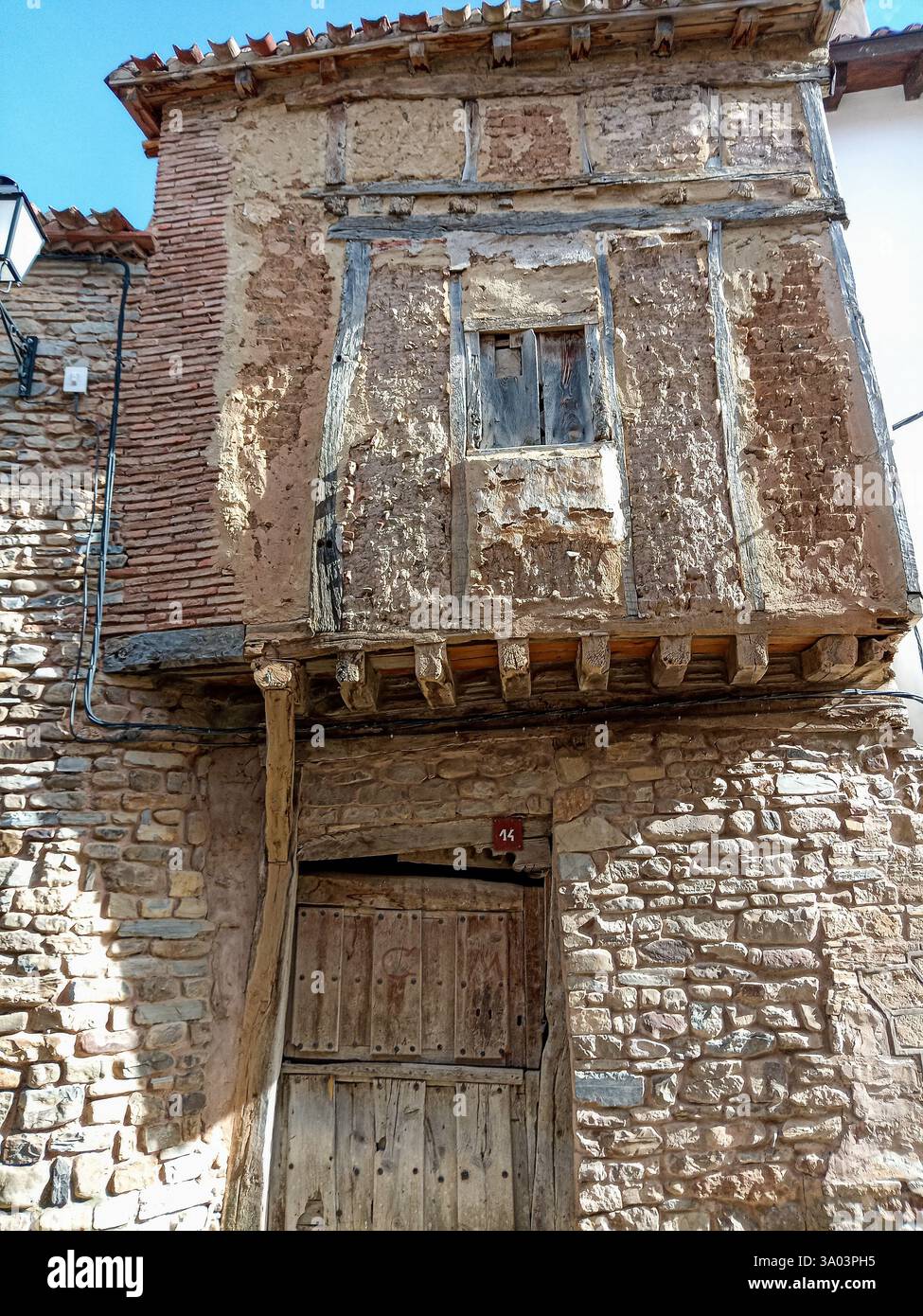 Ancient half-timbered house in Yanguas, Soria, featuring wooden beams, adobe walls, and a rustic ...