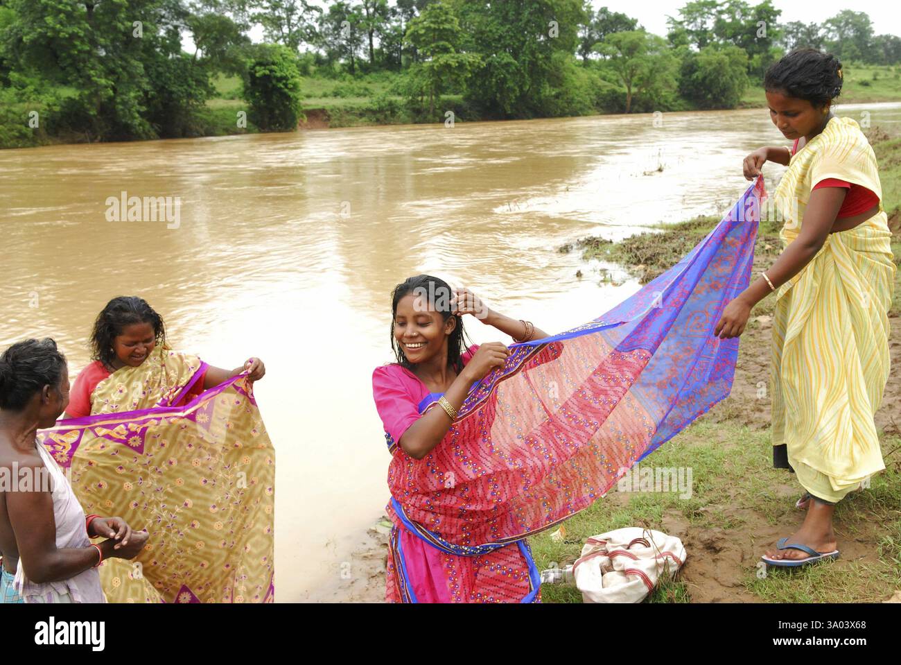 Ho tribes women helping for wearing sari after, Chakradharpur ...