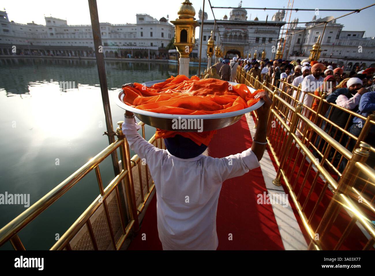 Karsevak at carrying Kara Prasad on causeway from Harmandir Sahib or ...