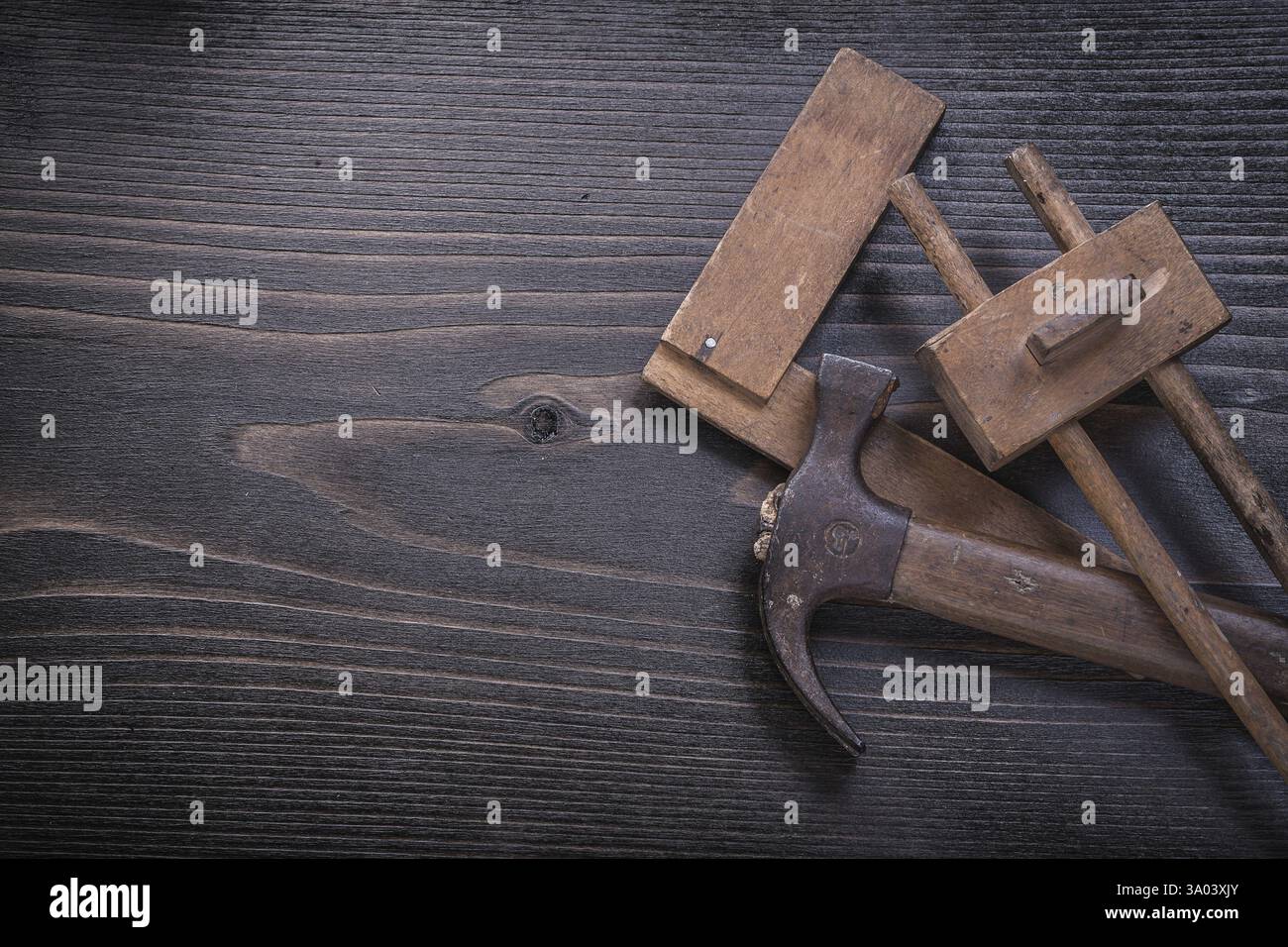 Age-old claw hammer square ruler carpenter gauge on wood board Stock ...