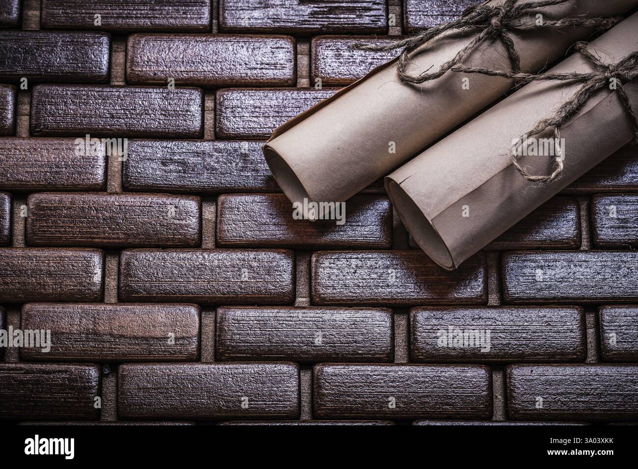 Aged paper rolls with string on wicker place mat top view Stock Photo ...
