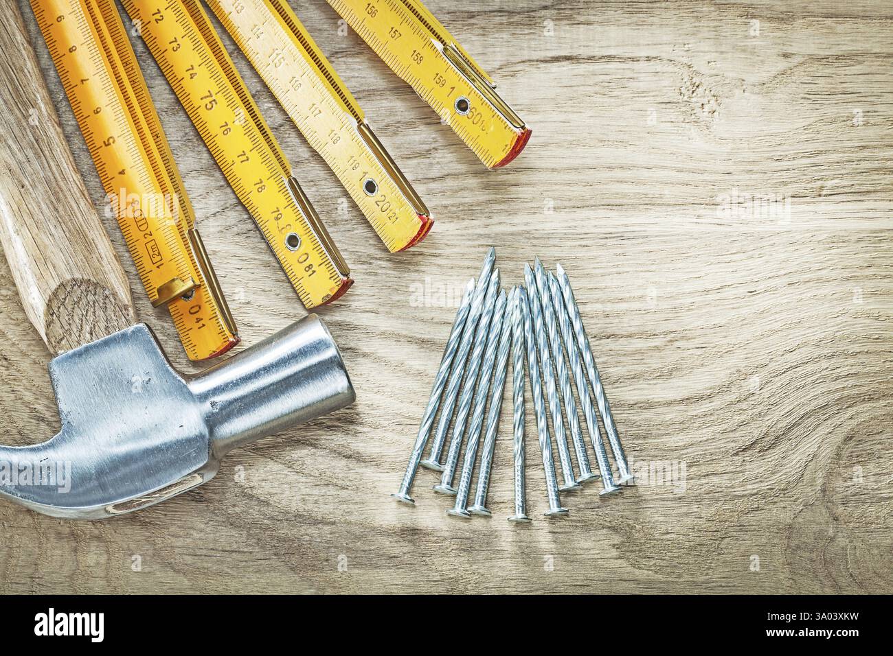 Assortment of claw hammer wooden meter construction nails on wood board ...