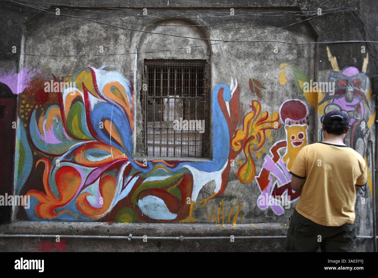 Artist doing wall graffiti at Bandra village in western suburbs of ...